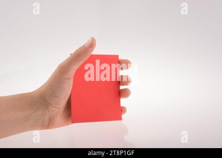 hand holding a red note paper on white background Stock Photo - Alamy