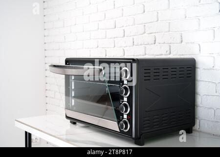 Mini electric oven against white brick wall in the kitchen Stock Photo ...