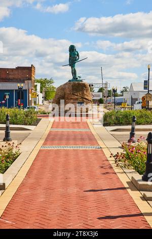 Passing of the Buffalo Native American statue with golden sun beside it ...