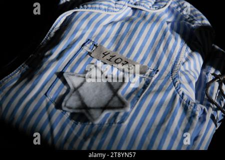 Prisoner uniform and Jewish badge on dark background, closeup ...