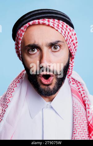 Arab wearing ghutra headdress with egal rope band and chatting on ...