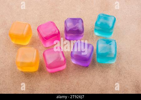 Fake colorful ice cubes on a brown background Stock Photo - Alamy