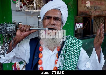 A fakir, a wandering Muslim ascetic performing strange feats and ...