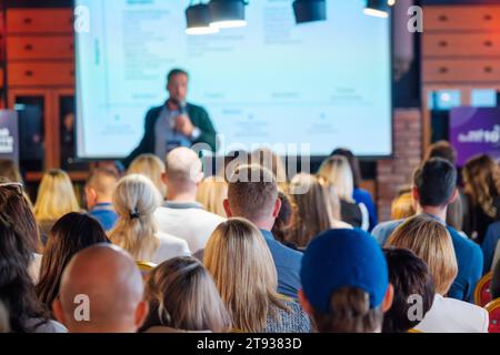 Back view of diverse businesspeople attending global workshop in ...