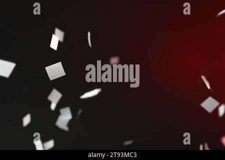 White confetti falling down, toned in red Stock Photo - Alamy