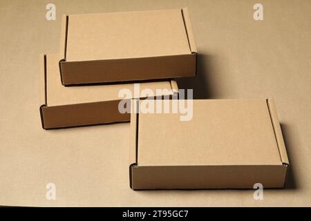 Many closed cardboard boxes on light brown background Stock Photo - Alamy