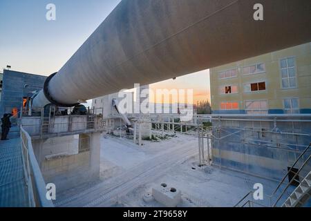 Rotating furnace for limestone roasting at plant in evening Stock Photo ...