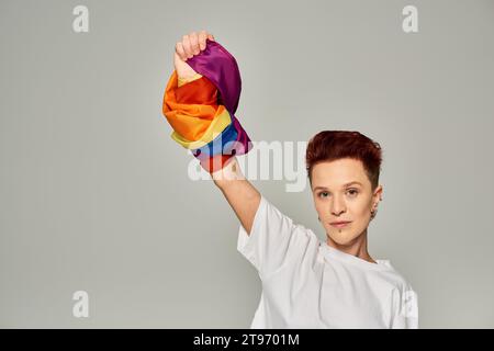 redhead bigender person in white t-shirt obscuring face with hands ...