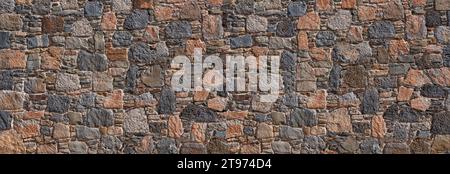 Wall made of various gray and blue-gray natural stones stacked in an ...