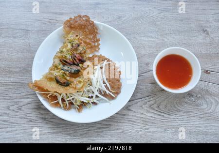 fried egg stuffed mussel with bean sprout topping garlic and dressing ...