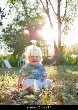 Baby is sitting on the grass. Selective focus. Nature Stock Photo - Alamy