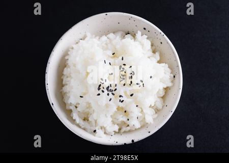 Japanese rice on cup isolated in black background Stock Photo - Alamy