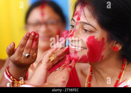 Married ladies smear red Sindoor or Vermillion, a ritual known as ...