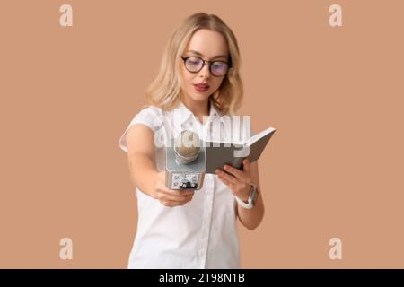 Portrait of female journalist with microphone and notebook taking ...