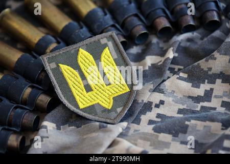 Ukrainian army symbol on machine gun belt lies on ukrainian pixeled ...