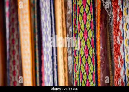 Many colorful belts with patterns. Folk art, handmade, Knitting of a ...