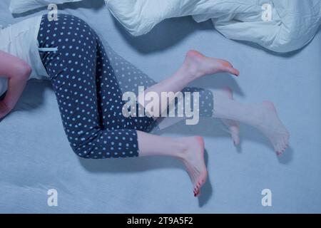 Woman With RLS - Restless Legs Syndrome. Sleeping In Bed Stock Photo ...