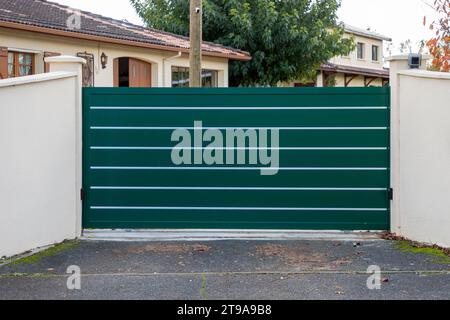 steel sliding high green metal gate on modern house street Stock Photo ...