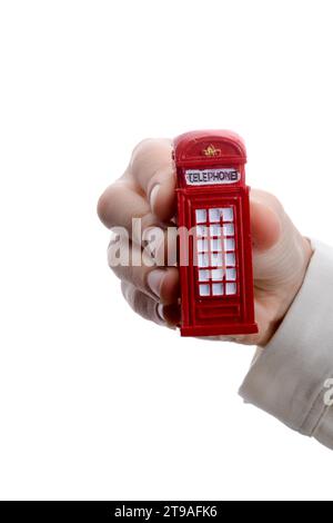 Telephone booth in hand on a white background Stock Photo - Alamy