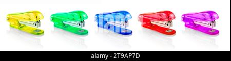 Set of stationery with staplers on blue background Stock Photo - Alamy