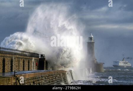 Waves crash over the Tynemouth pier lighthouse at the mouth of the ...
