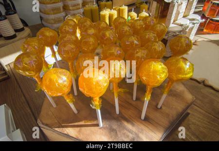 Honey lollipops displayed in a traditional market stall. Healthy candy ...