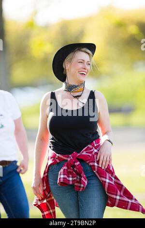 Happy woman looking away while standing on city street Stock Photo - Alamy