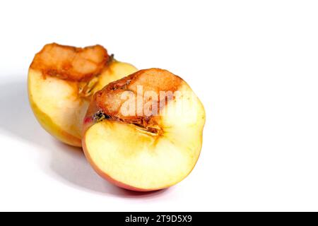 Rotting apple against white background Stock Photo - Alamy