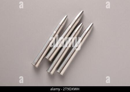 Many metal bullets on light grey background, flat lay Stock Photo - Alamy