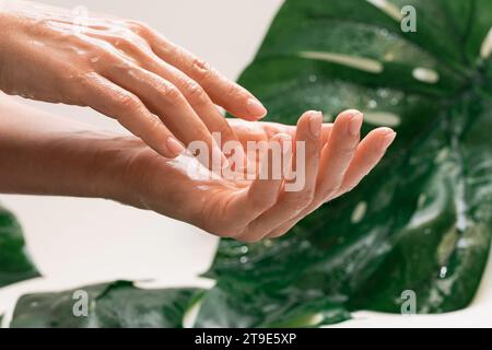 Wet female hands with moisturized oily skin Stock Photo - Alamy