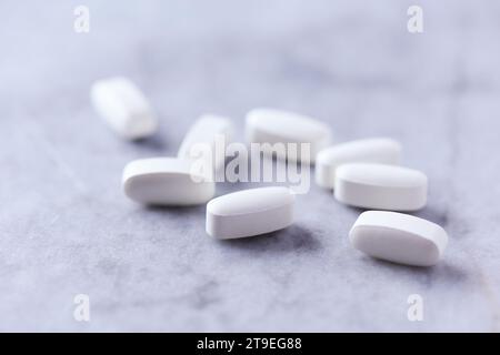 Beta - Alanine tablets. A dietary supplement on bright stone background ...
