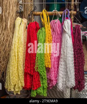 Empty mesh bags of various color at a market place Stock Photo - Alamy