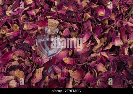 Heart shaped bottles on dry rose petal background Stock Photo - Alamy