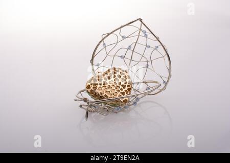 Heart shaped gold color metal object in hand Stock Photo - Alamy
