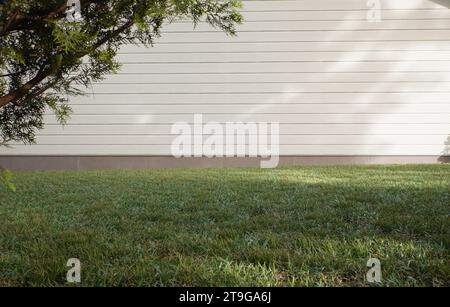 Traditional American home with two garages, a driveway and a large tree ...