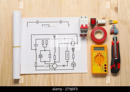 Flat lay composition with wiring diagrams and digital multimeter on ...