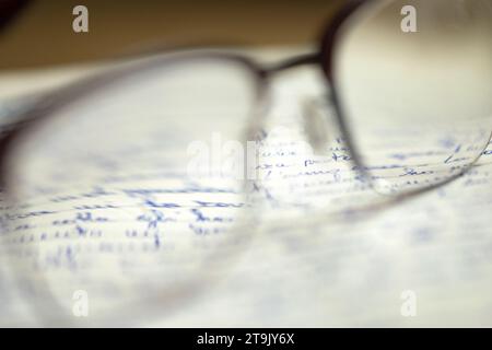 handwritten sheet with the writing seen through a pair of glasses Stock ...