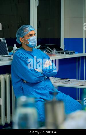 a tired surgeon is sitting in the operating room Stock Photo - Alamy
