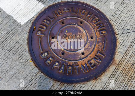 Street lighting manhole cover in Los Angeles. High voltage electricity ...