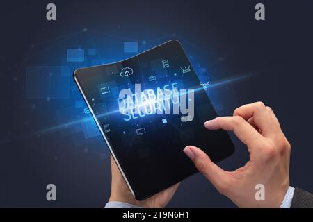 Businessman holding a foldable smartphone with DATABASE SECURITY ...