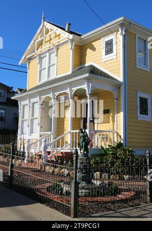 Charming two story yellow house with a large front porch on wooded lot ...