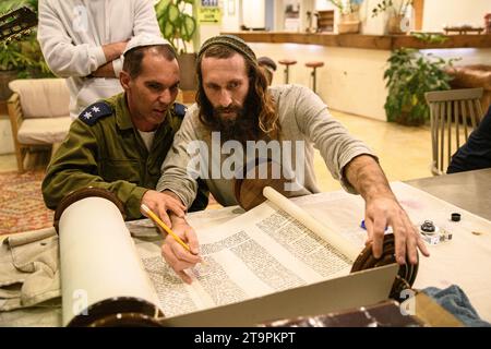 Shfaim, Israel. 26th Nov, 2023. Members of Kibbutz Kfar Azza gather to ...