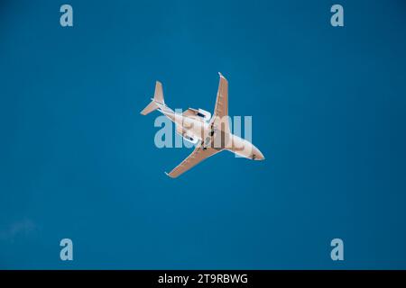 private white jet plane in the blue sky Stock Photo - Alamy