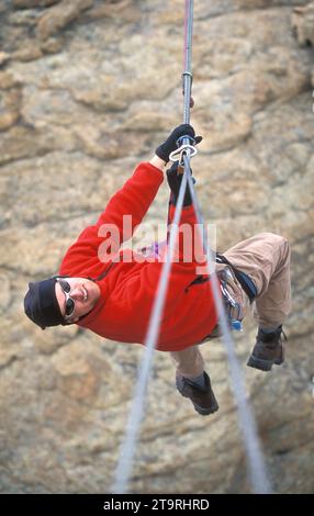Climber crossing gorge by tyrolean traverse, Estes Park, Colorado Stock ...