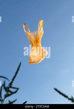 Used plastic bags floating in the air and sky, garbage and pollution ...