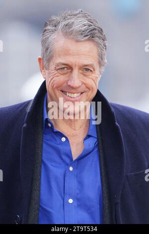 Hugh Grant during a photo call with the cast of Wonka at Potter's Field ...