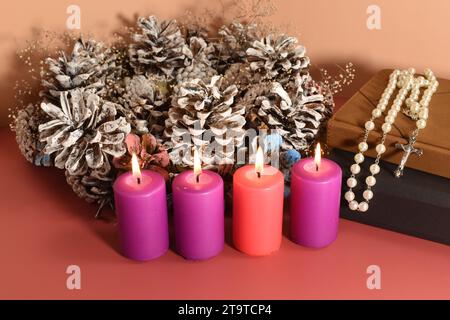 Four Advent candles, rosary and prayer books. Advent concept Stock ...