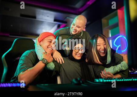 Diverse team of professional female gamers celebrating victory in ...