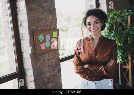 Portrait of gorgeous classy lady toothy smile folded arms empty space ...