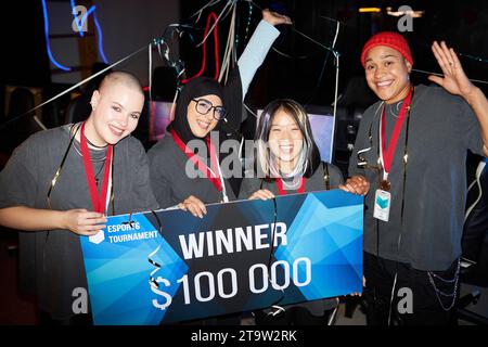 Diverse team of professional female gamers celebrating victory in ...